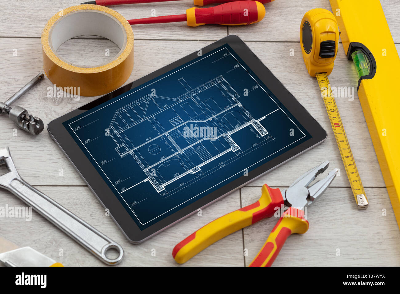 Tablet with construction tools and blueprint concept Stock Photo - Alamy