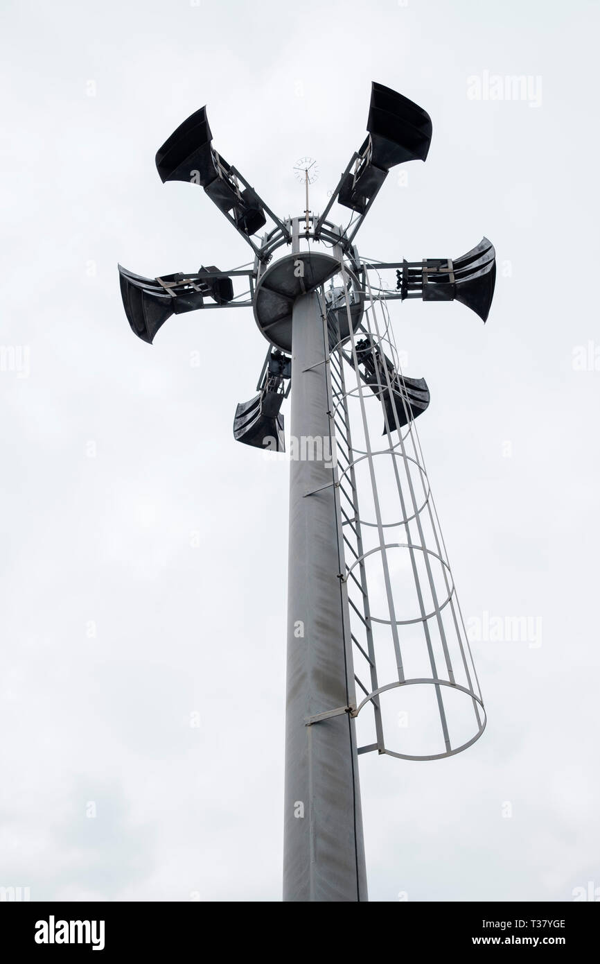 public address system, loudspeakers on mast outside against white sky ...