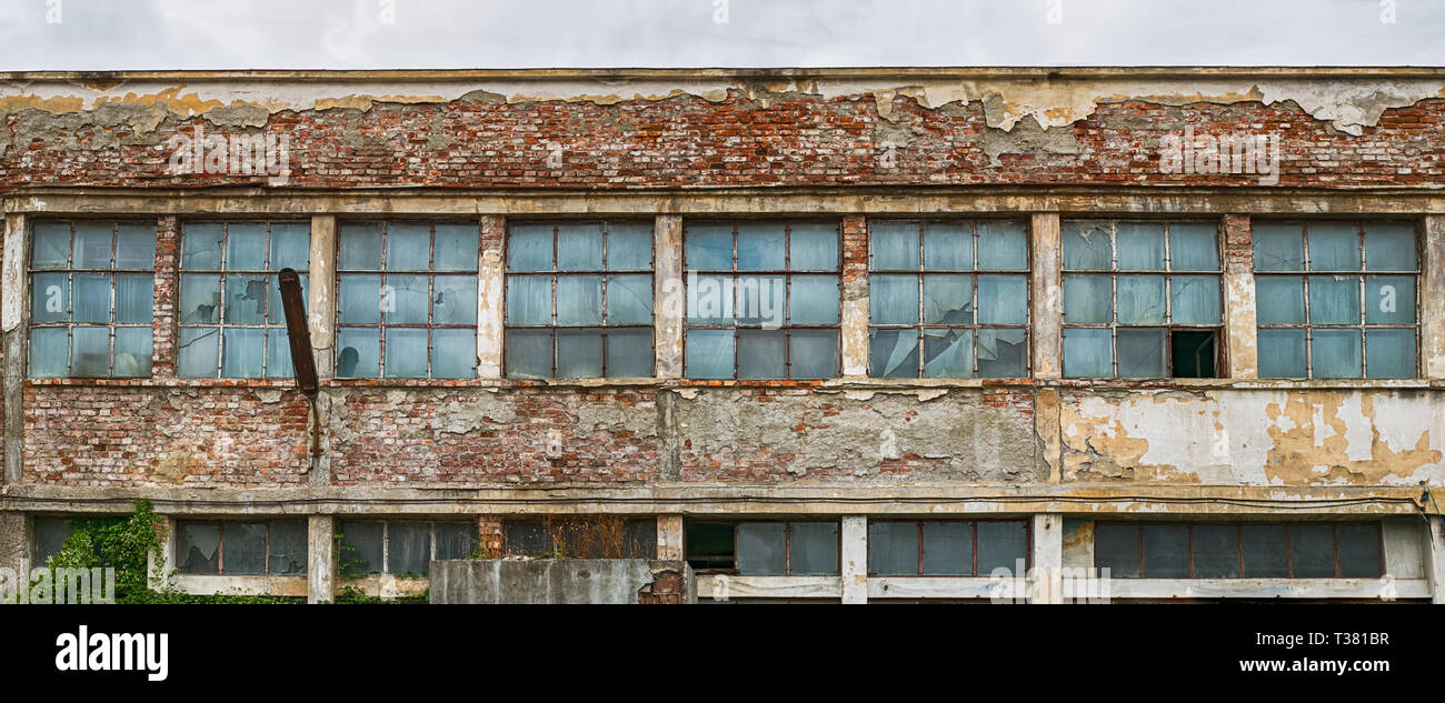 abandoned factory warehouse with broken windows Stock Photo - Alamy