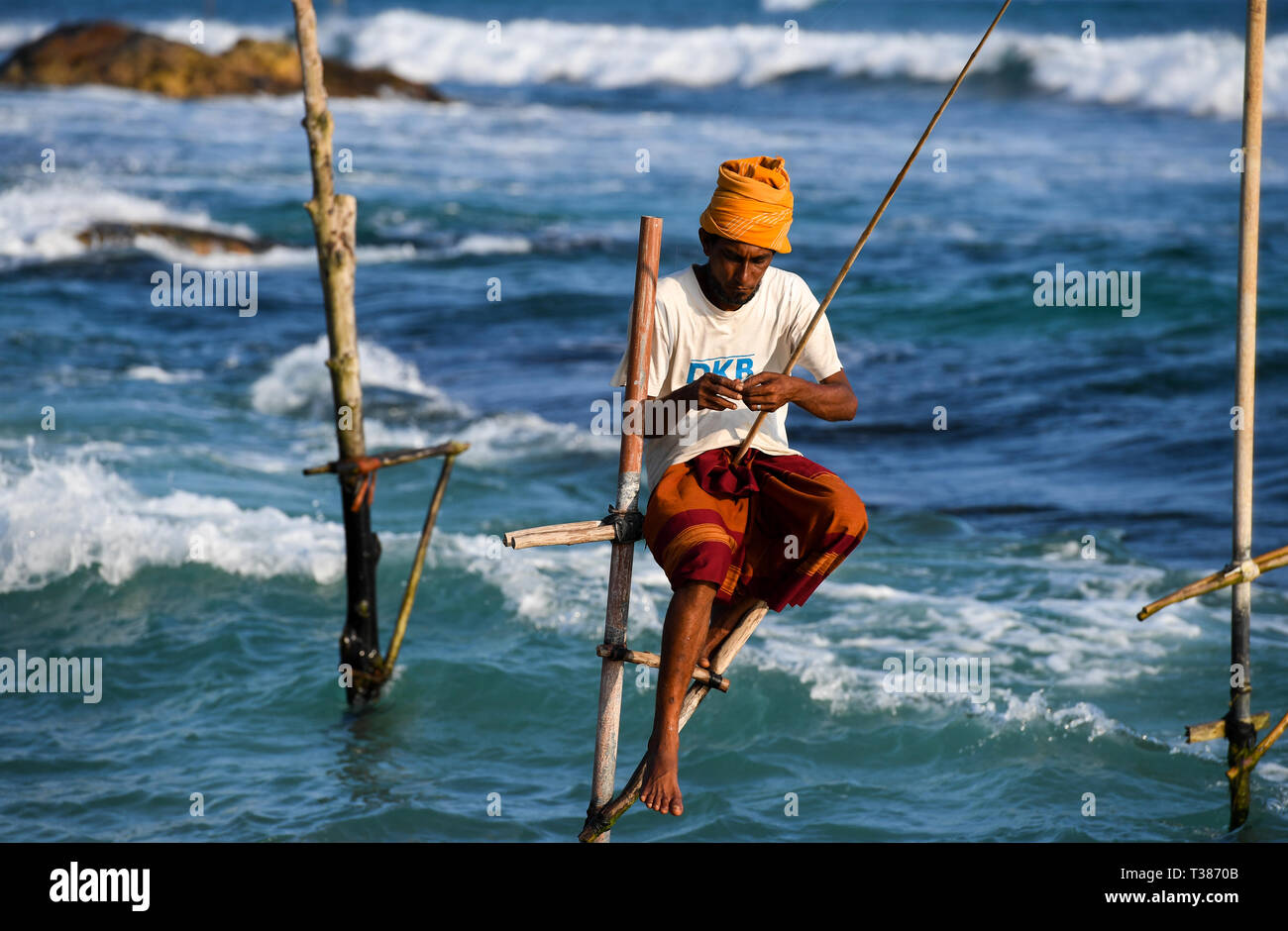 Colombo, Sri Lanka. 7th Apr, 2019. A stilt fisherman is seen at a beach ...