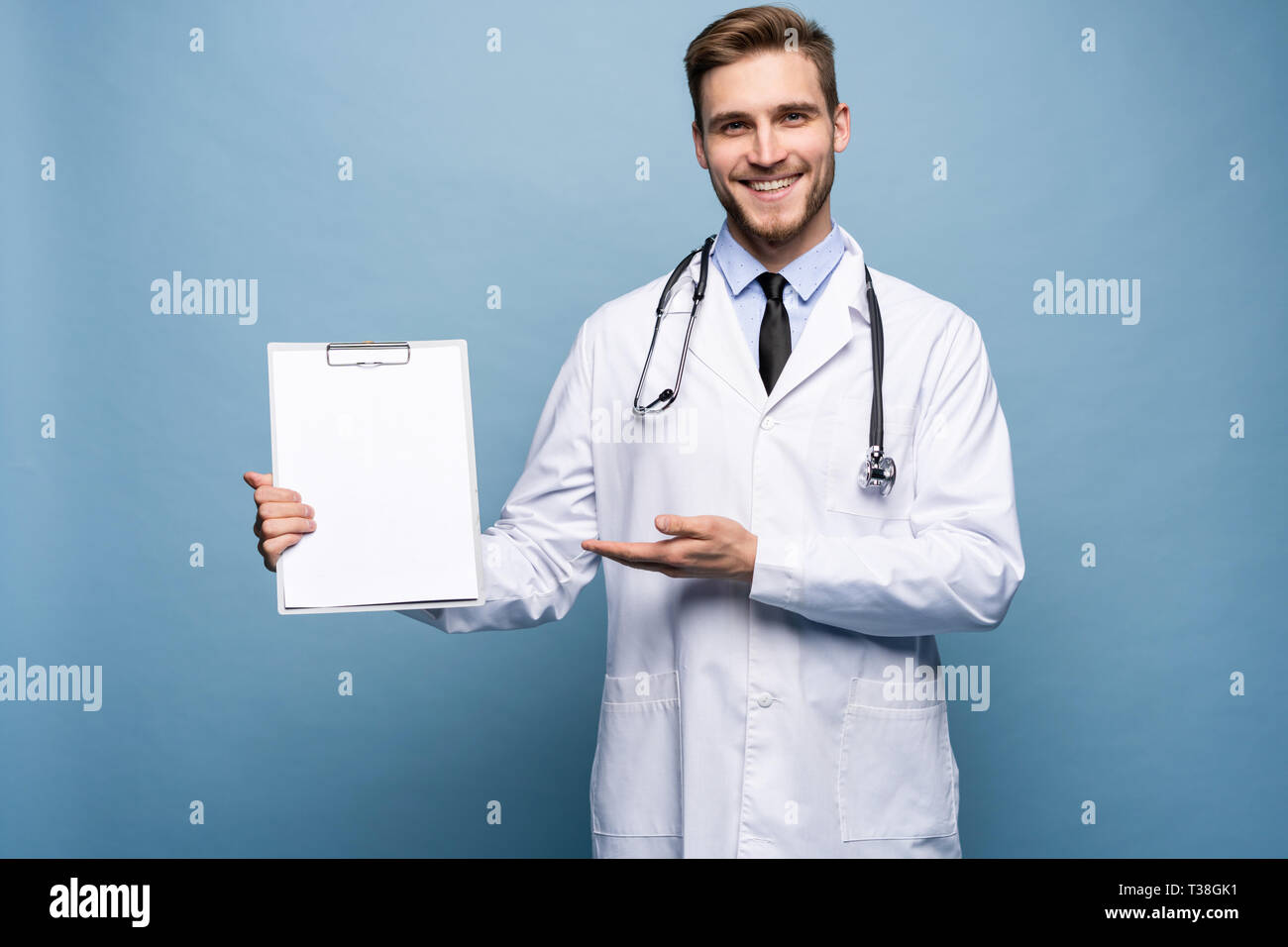 Male Doctor standing with folder, Doc is wearing white uniform and a ...