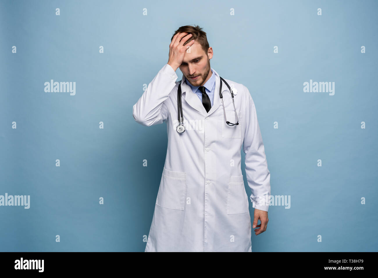 Doctor young man, medical professional terrified and nervous expressing ...