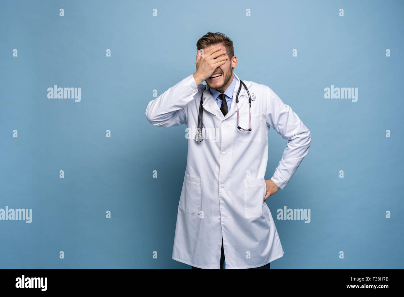 Doctor young man, medical professional terrified and nervous expressing ...