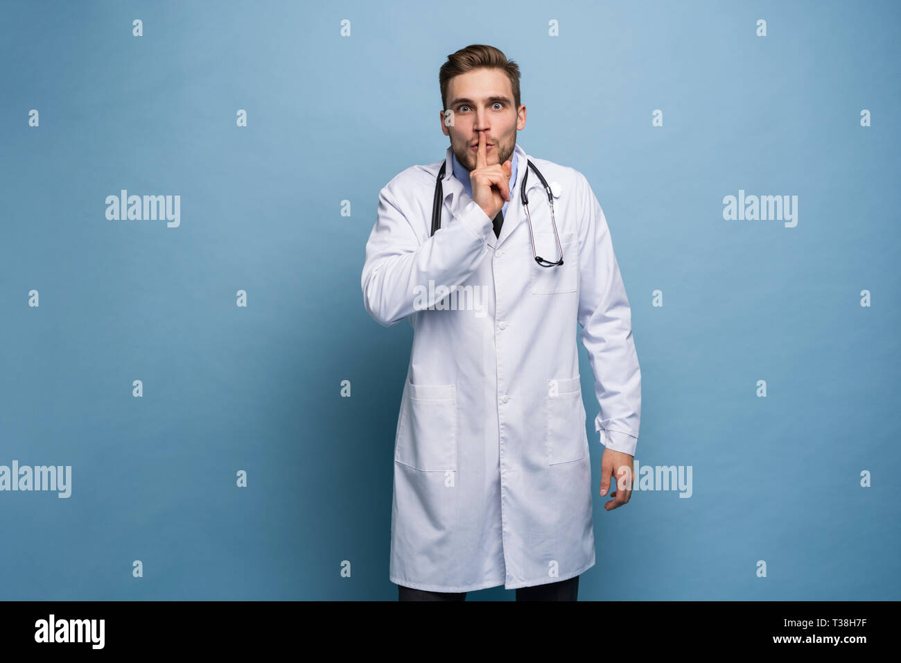 Doctor young man, medical professional terrified and nervous expressing ...