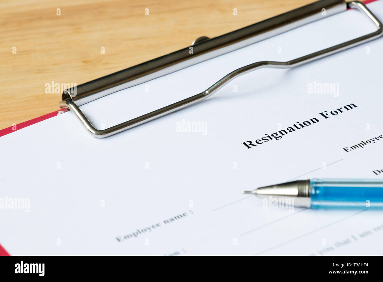 Resignation form on wood desk background Stock Photo - Alamy