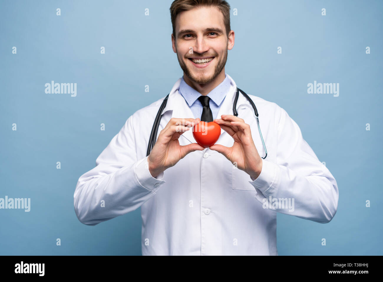 healthcare and medical concept - male doctor with heart Stock Photo - Alamy