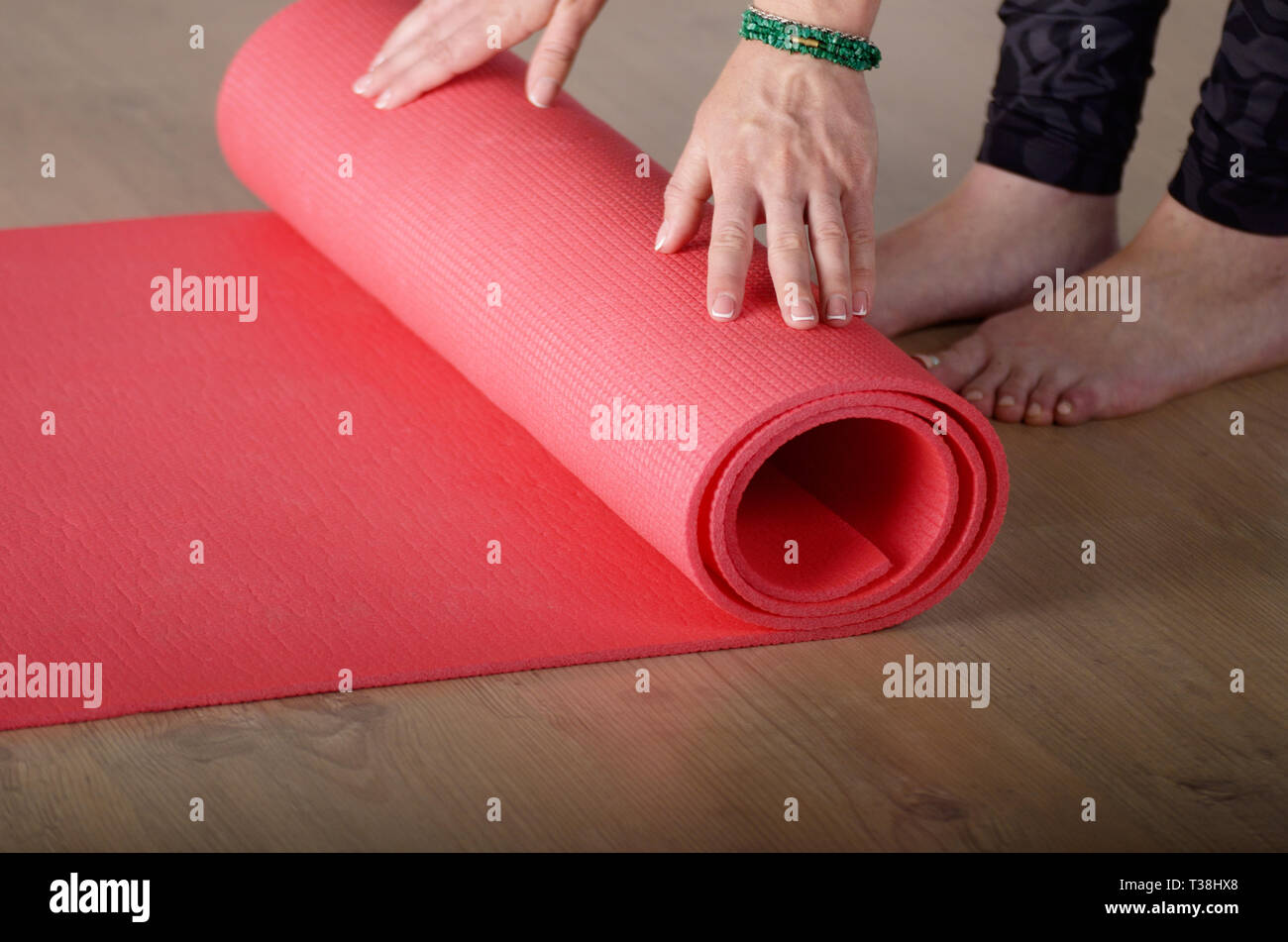 Female hands unrolling yoga mat before workout exercise. Healthy ...