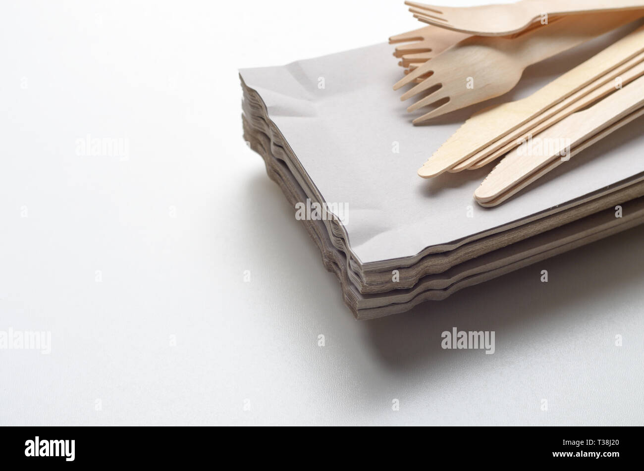 Wooden single use kitchenware and paper plate on white background ...