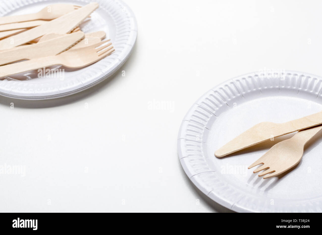 Wooden single use kitchenware and paper plate on white background ...