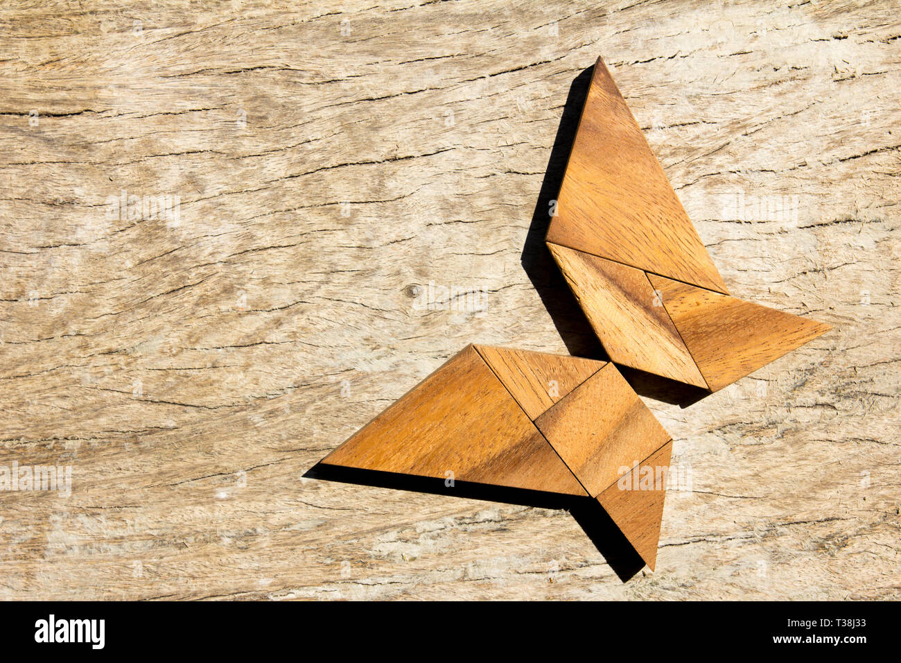 Wooden tangram puzzle in flying butterfly shape background Stock Photo ...