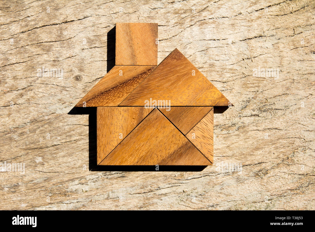 Wooden tangram puzzle in home shape for dream home or happy life ...