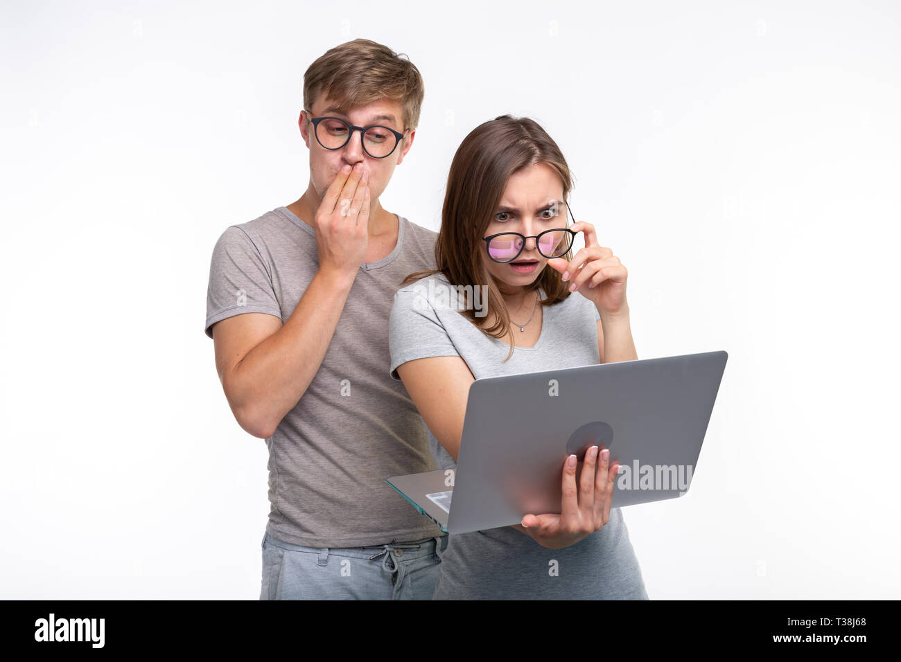 Nerds, study, people concept - a couple of people look at the laptop ...