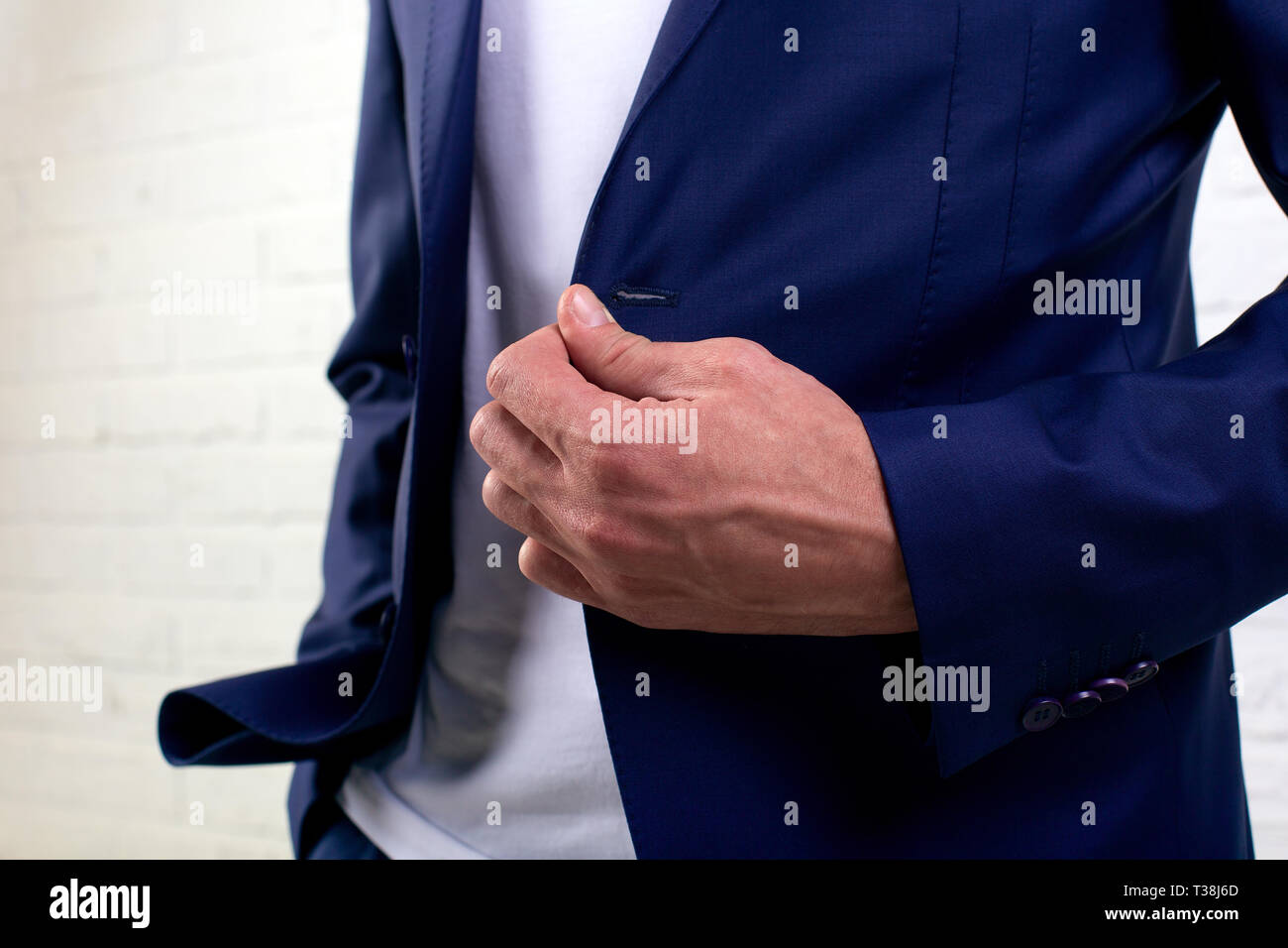 Businessman putting on jacket standing hi-res stock photography and ...