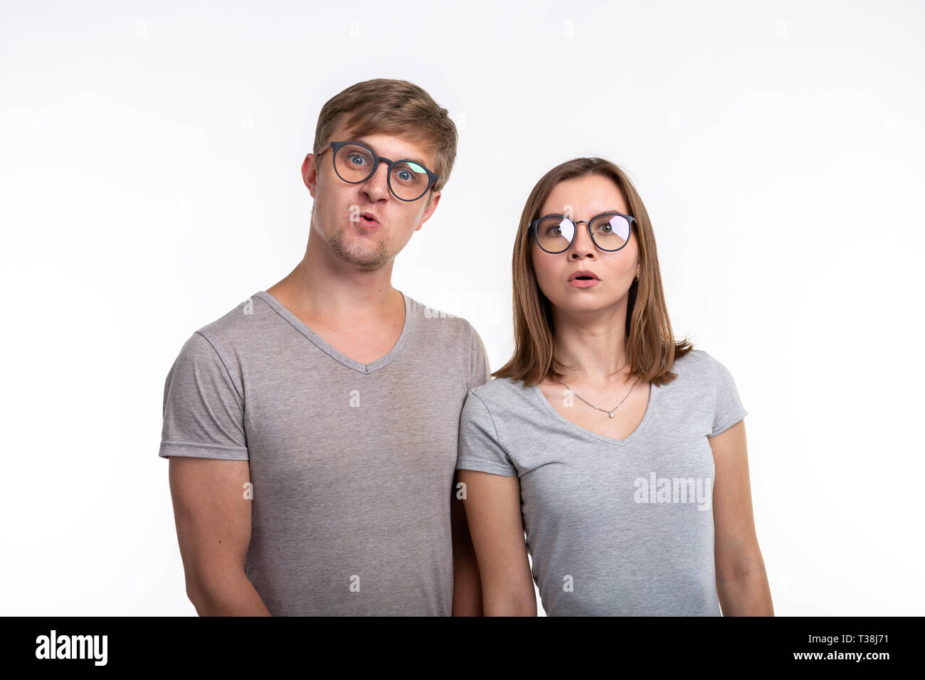 Education, people concept - a couple of young people in glasses look ...