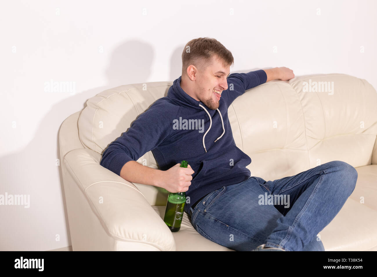 Depression and alcoholism concept - aggressive young man sitting on a ...