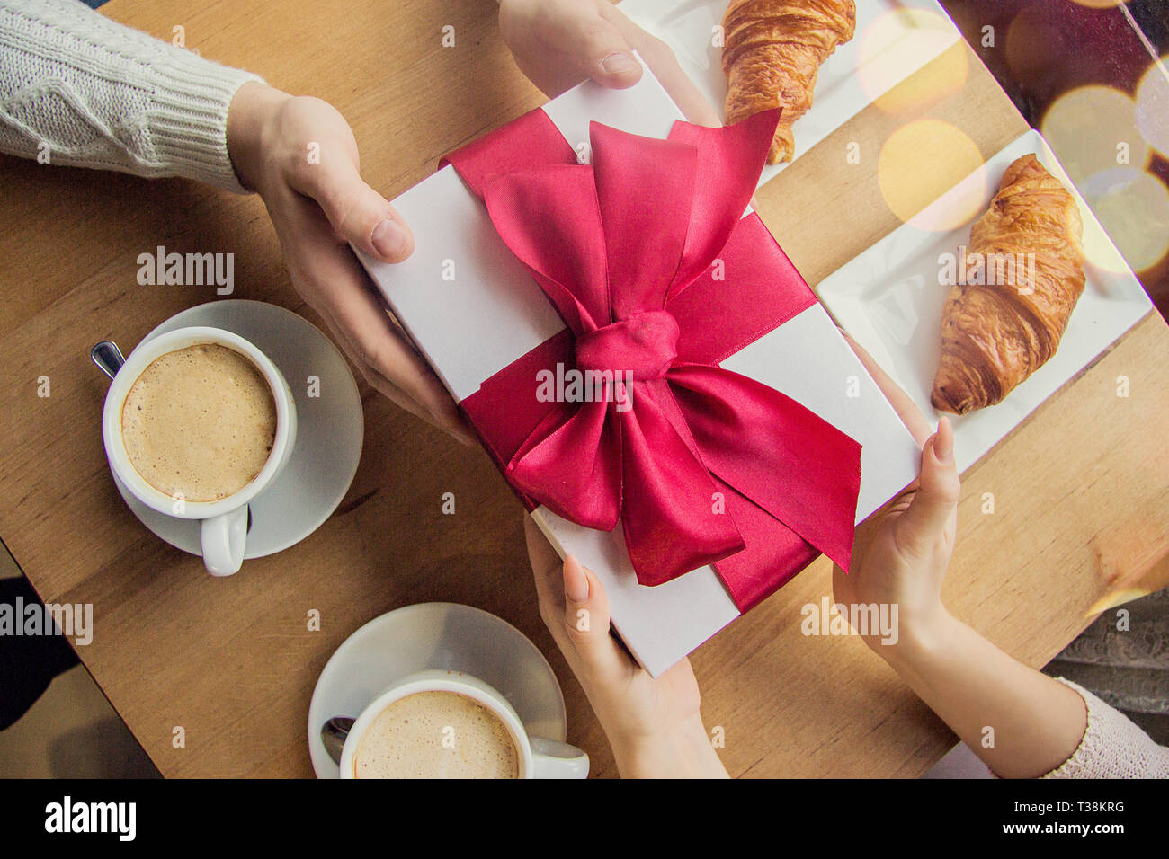Top view of man hands giving present to his beloved girlfriend. Woman ...