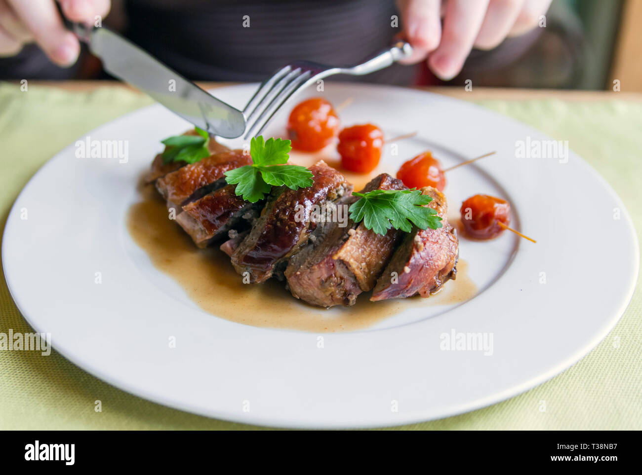 Duck roll in demi-glace sauce on a plate Stock Photo - Alamy