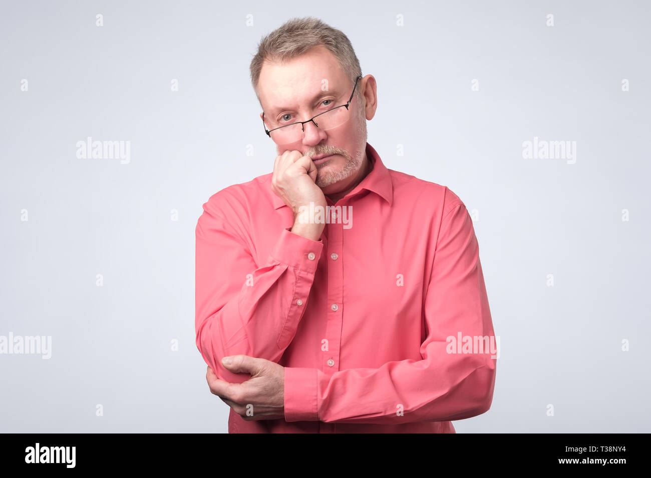 Senior european man thinking about his problems, expressing some doubts ...