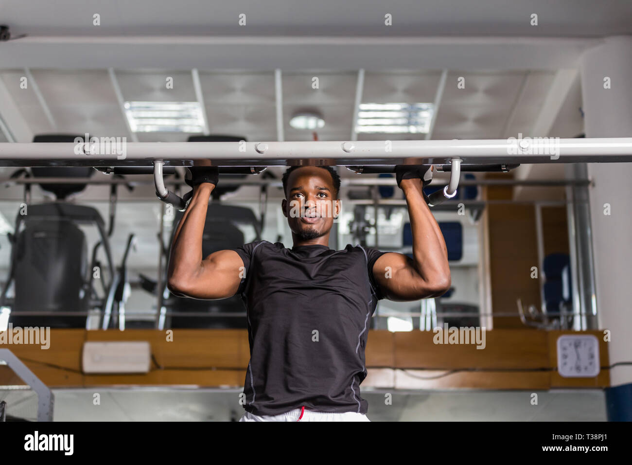Black African American young man doing pull up workout at the gym Stock ...