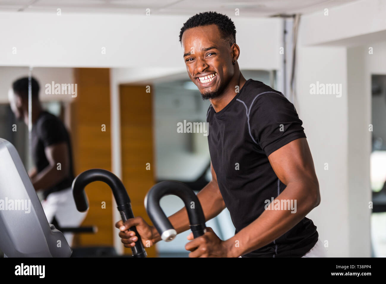 Black African American young man doing cardio workout at the gym Stock ...