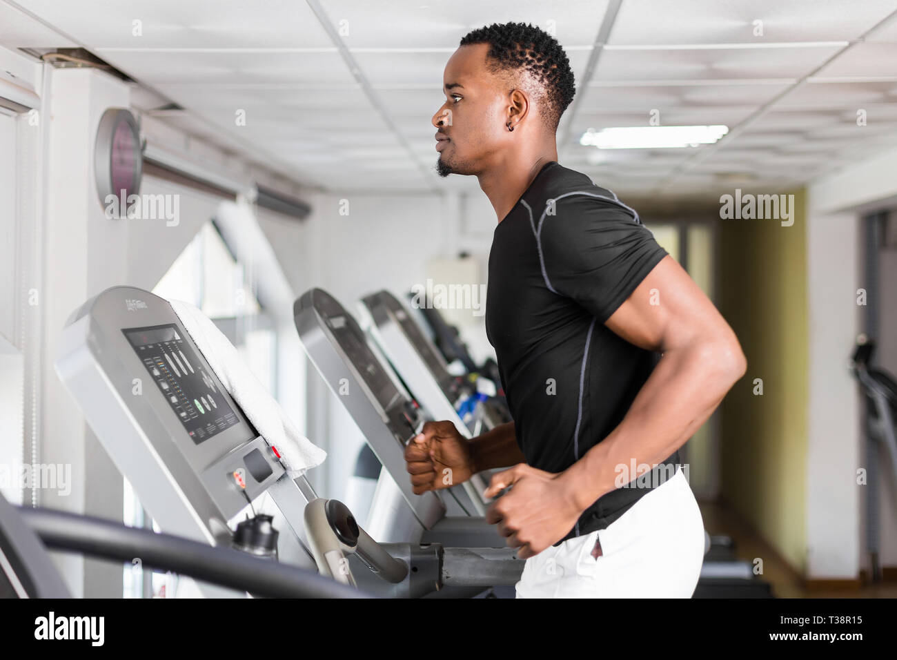 Black African American young man doing cardio workout at the gym Stock ...