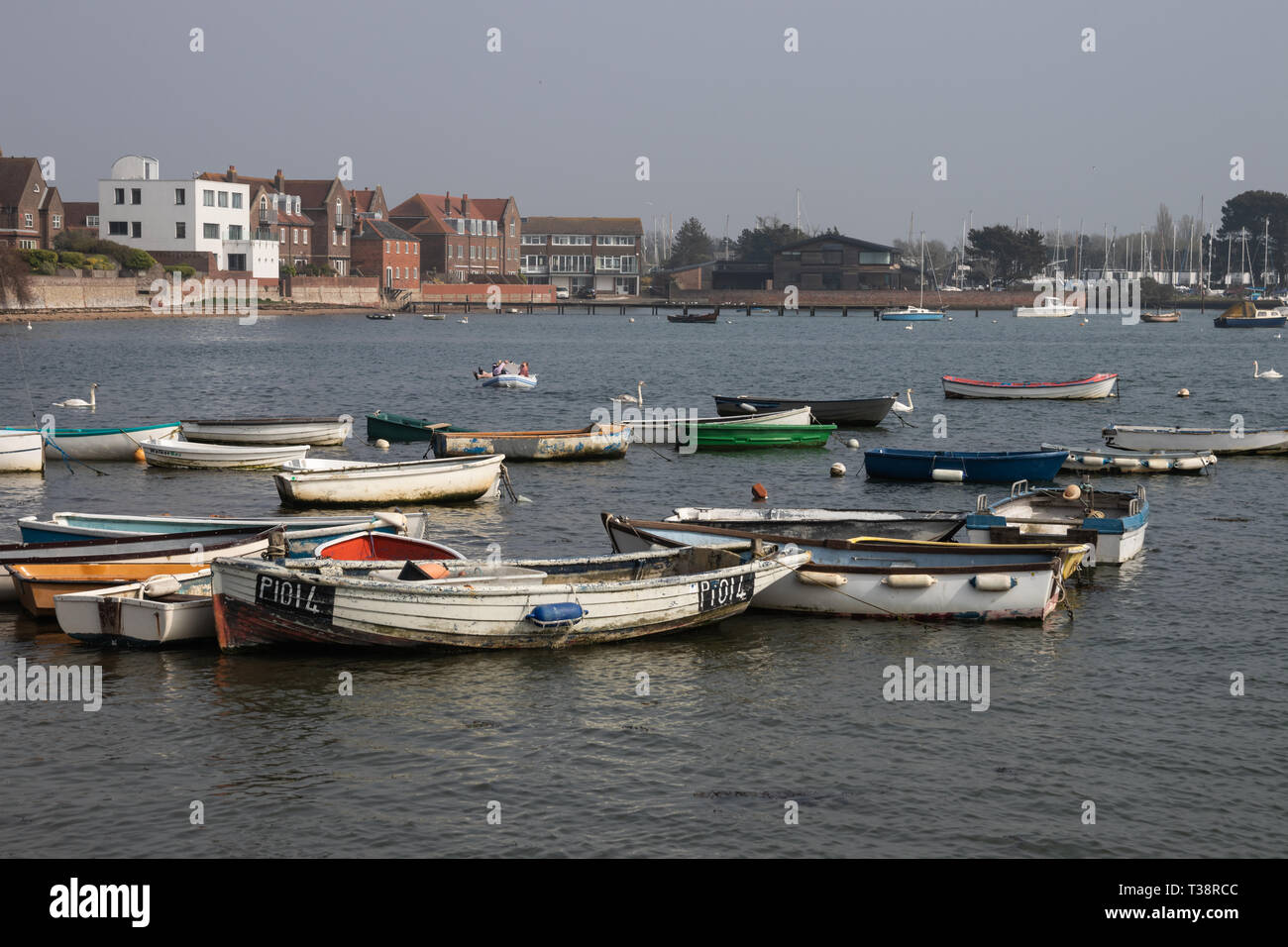 Various wooden boats tied together in a harbour Stock Photo - Alamy