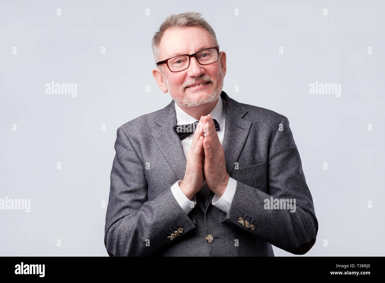 Please help me now. Senior man in suit need a help. Isolated on gray ...