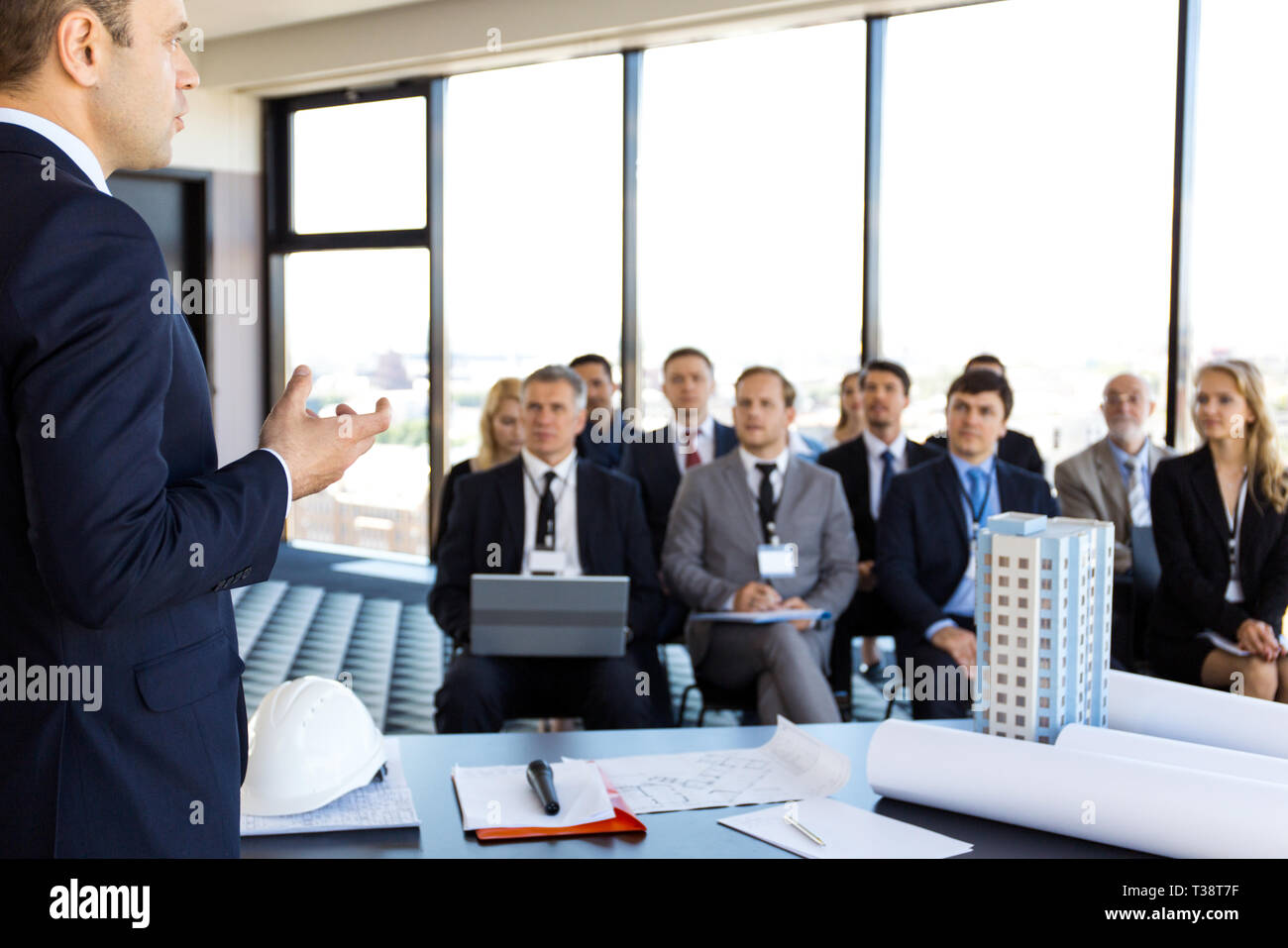 Audience of business people and investors sitting at presentation room ...