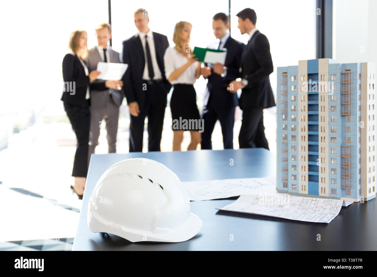 Business meeting of architects and investors, model of modern multi ...