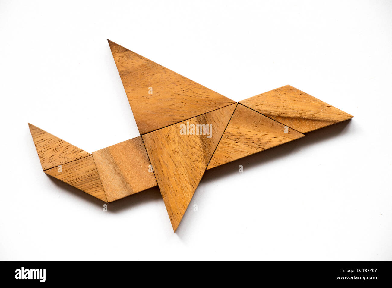 Wooden tangram puzzle in airplane shape on white background (Concept ...