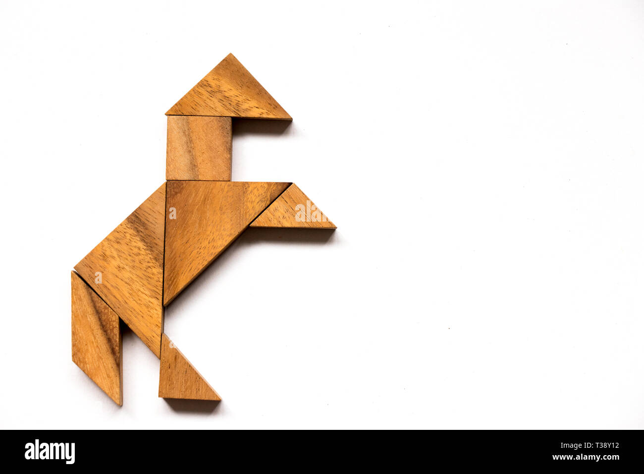 Wooden tangram in horse shape on white background (Concept for energy ...