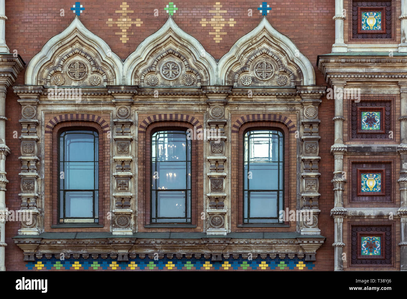 Three windows with figured stucco and painted on the background of a ...