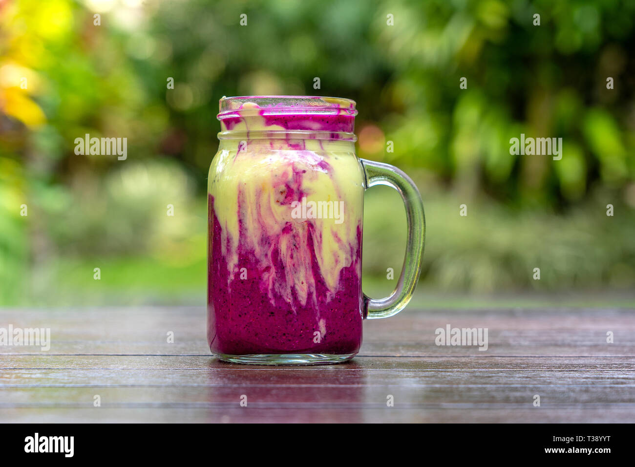Fresh tropical smoothie with red dragon fruit, green avocado, yogurt ...