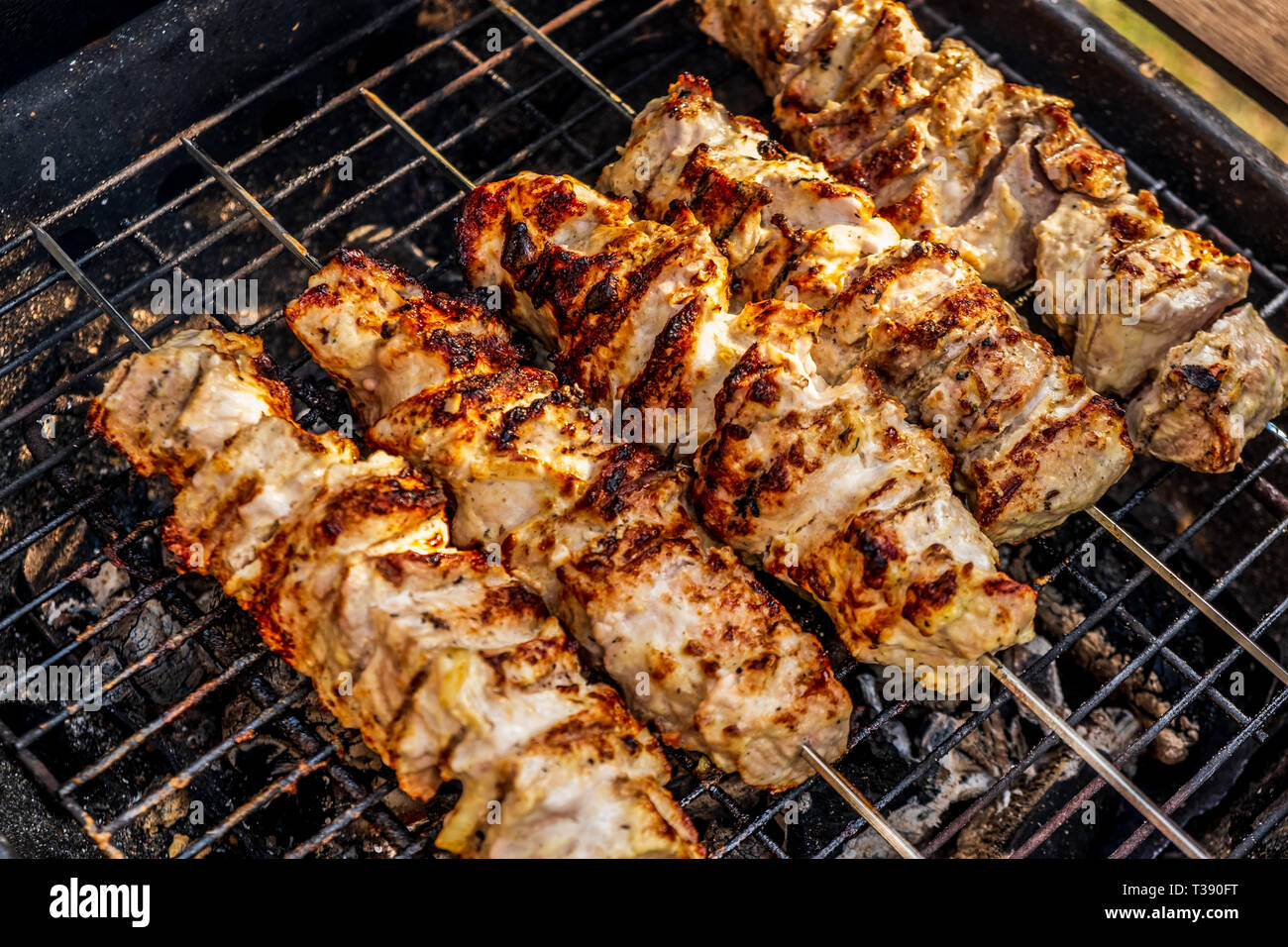 Traditional shashlik cooking on a grill isolated Stock Photo - Alamy