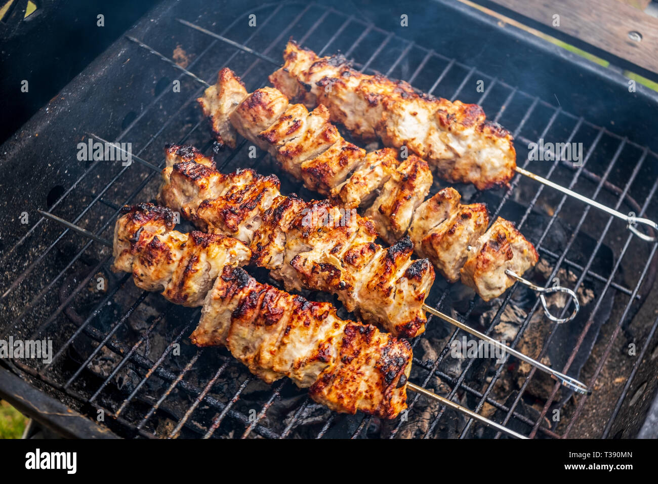 Traditional shashlik cooking on a grill isolated Stock Photo - Alamy