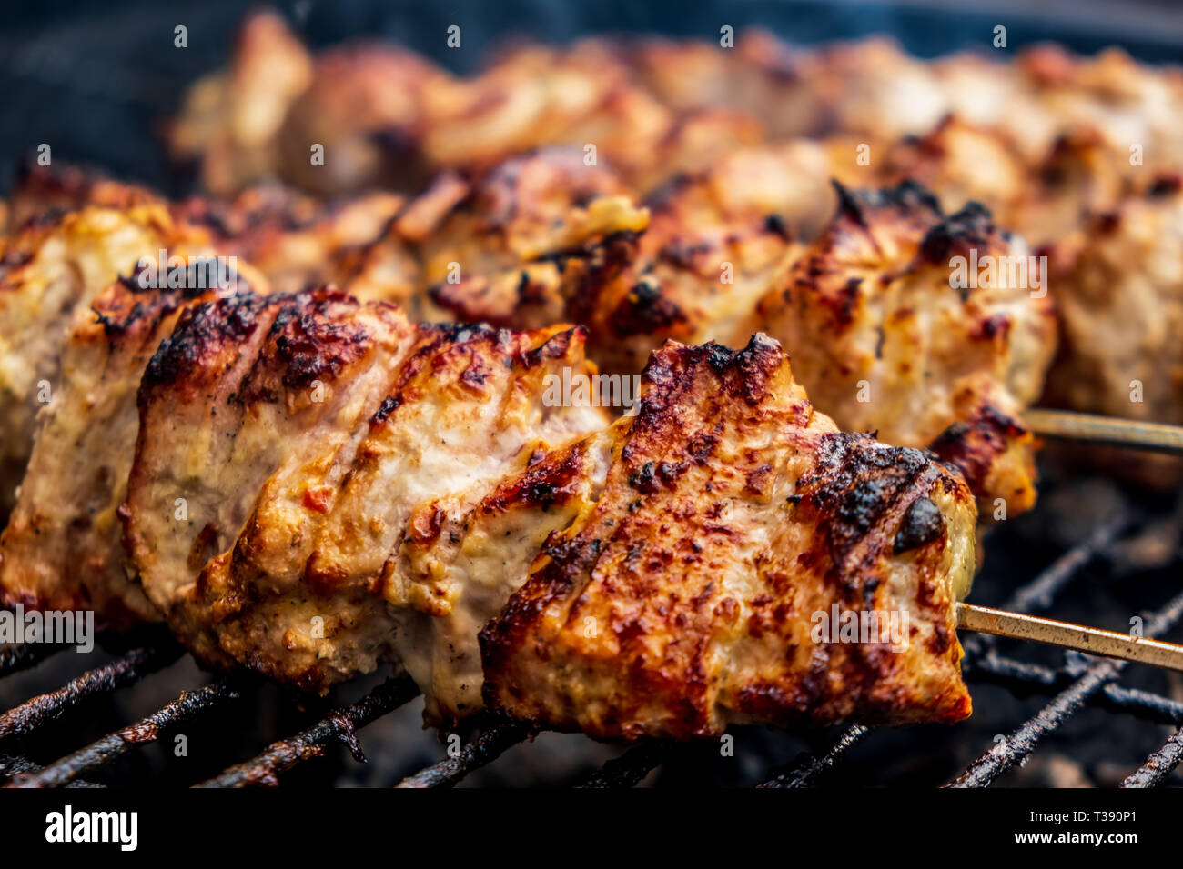 Traditional shashlik cooking on a grill isolated Stock Photo - Alamy