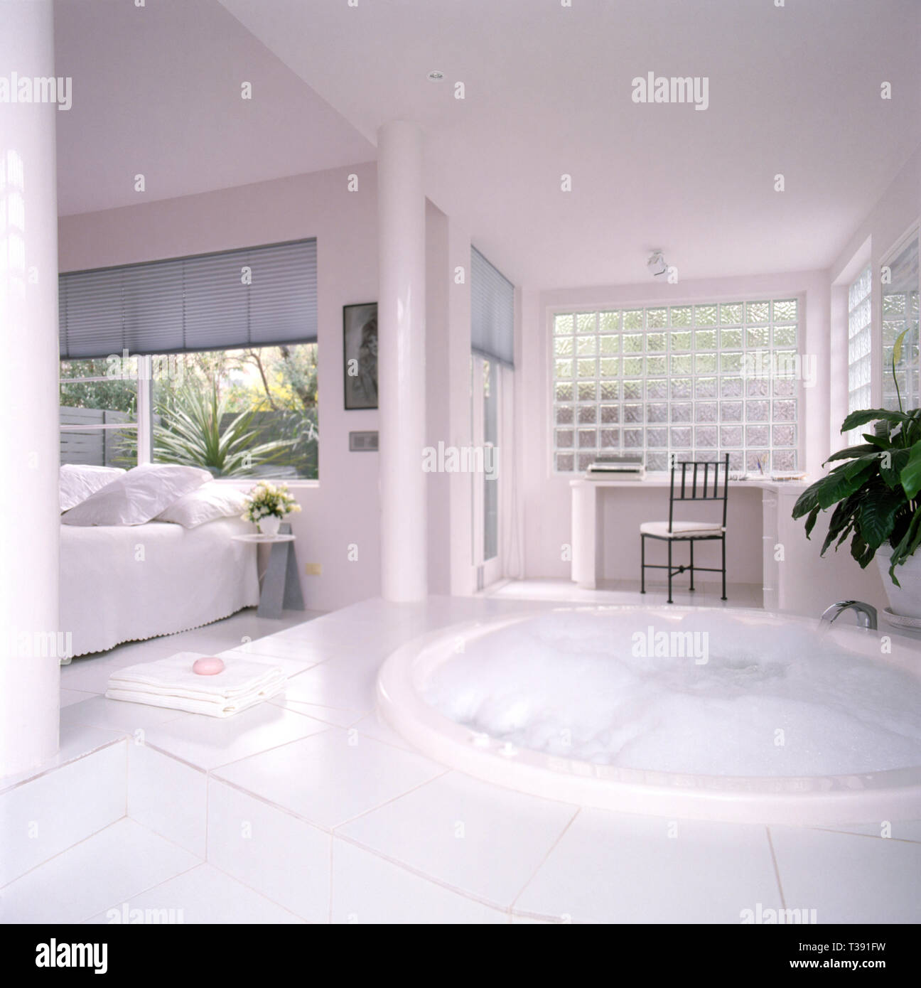 Circular spa tub on a split level floor in an open-plan ensuite ...