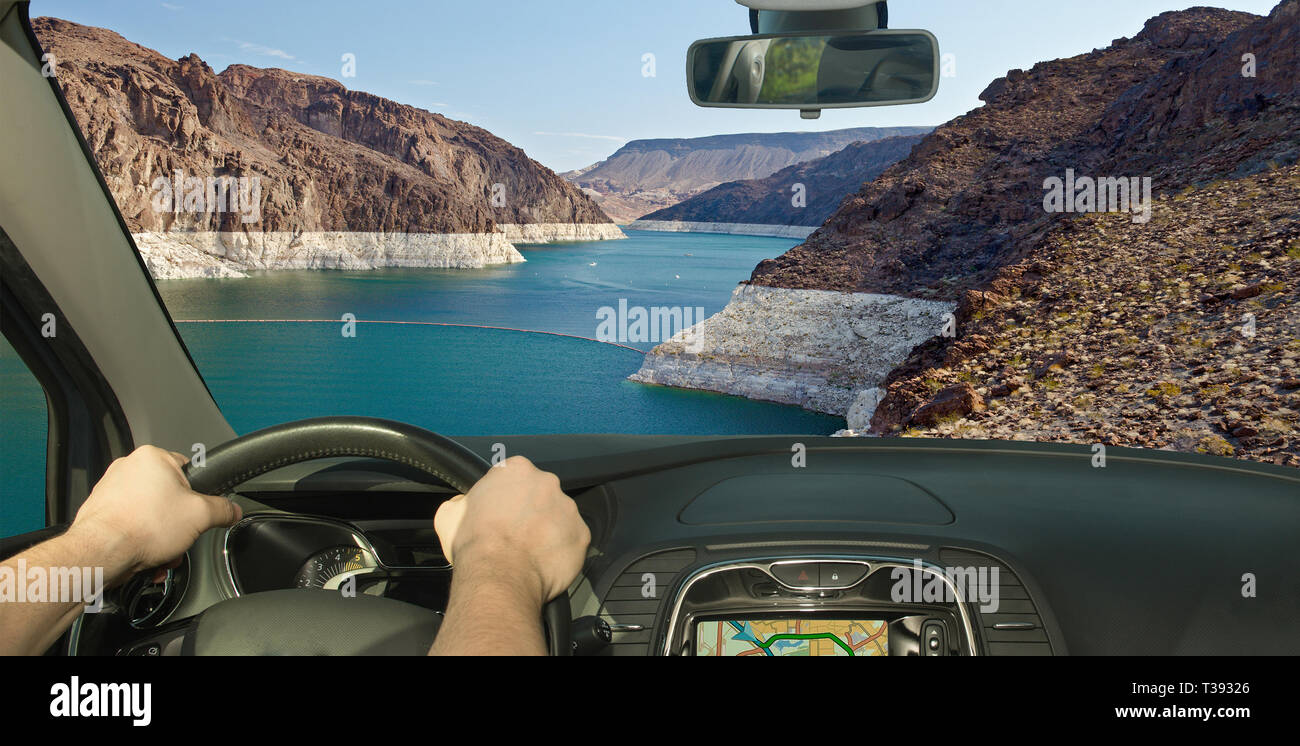 Driving a car with view of Colorado river in front of the Hoover Dam on ...