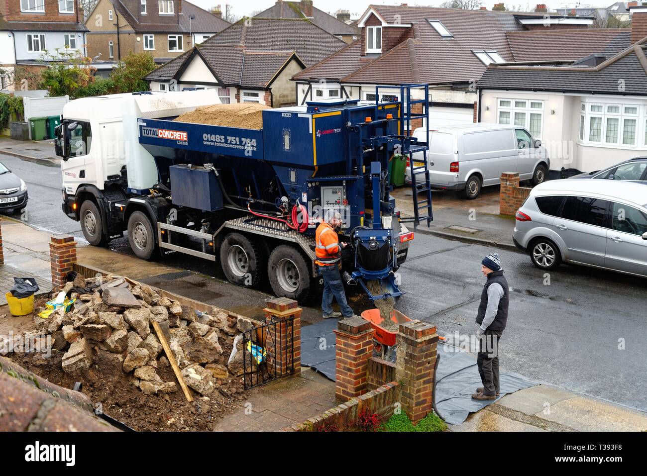 A lorry delivering ready made concrete to a suburban house undergoing ...