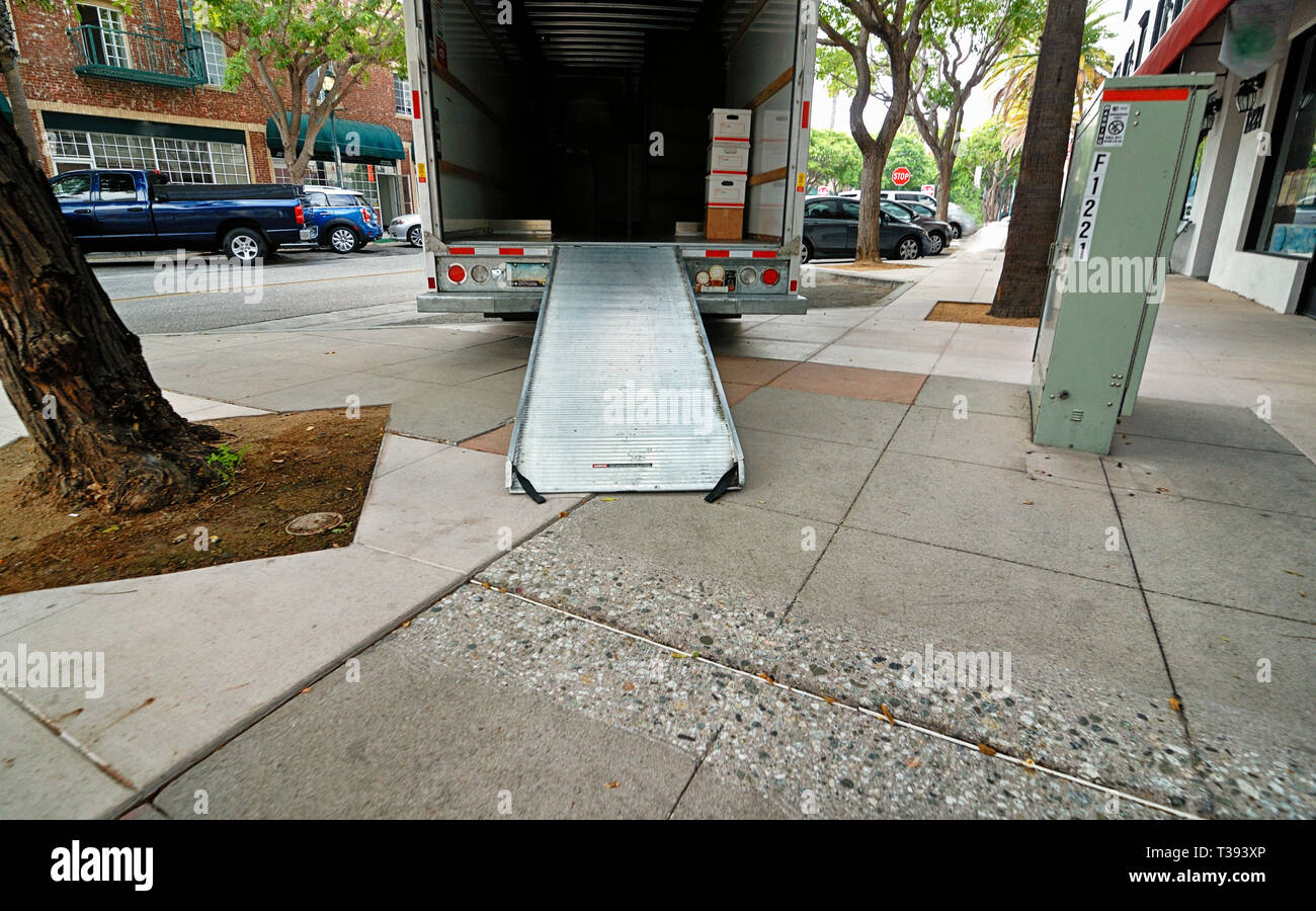 The ramp off the back of a delivery truck landing on a sidewalk Stock ...