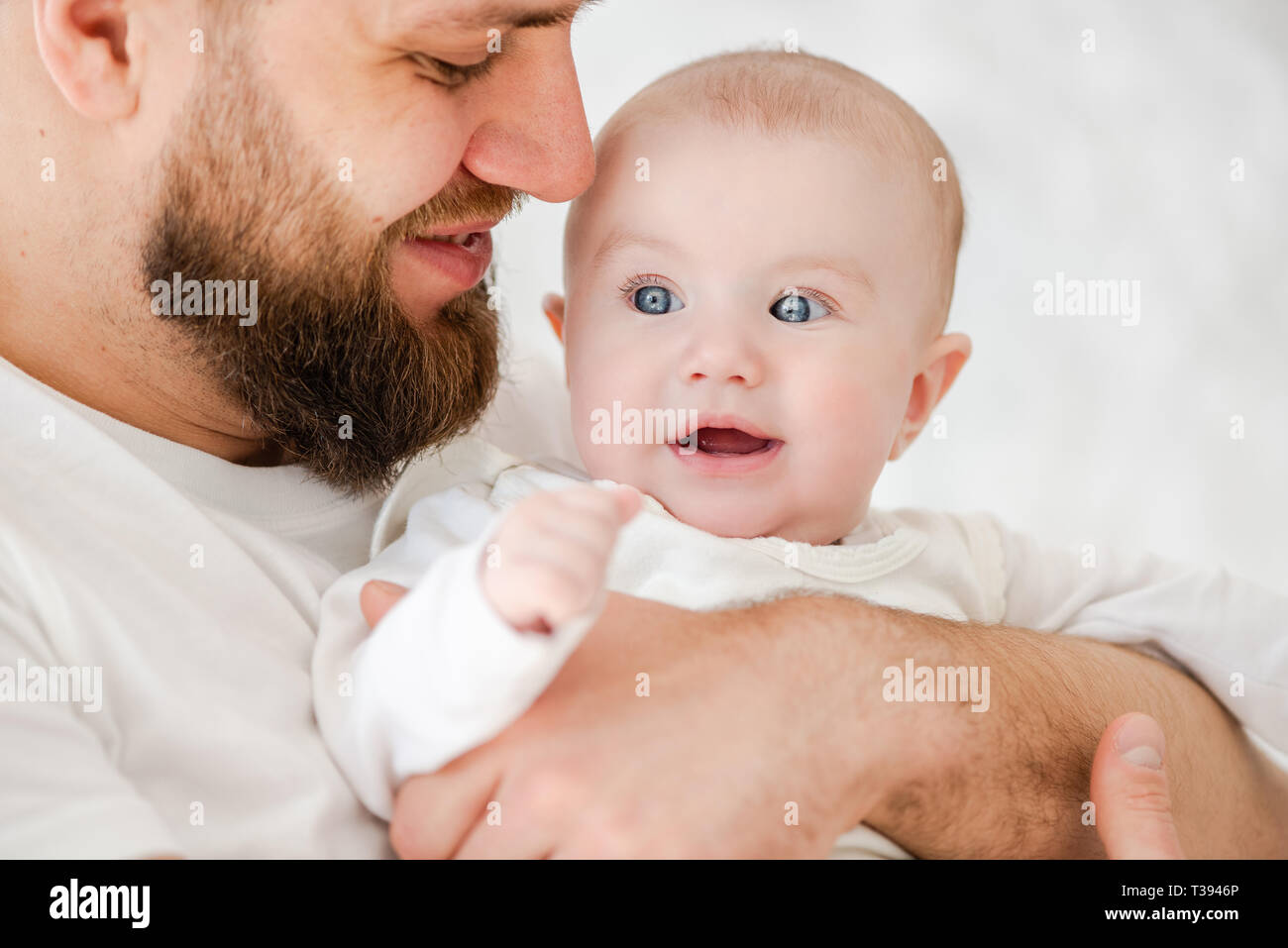Smiling father and baby girl, white background Stock Photo - Alamy