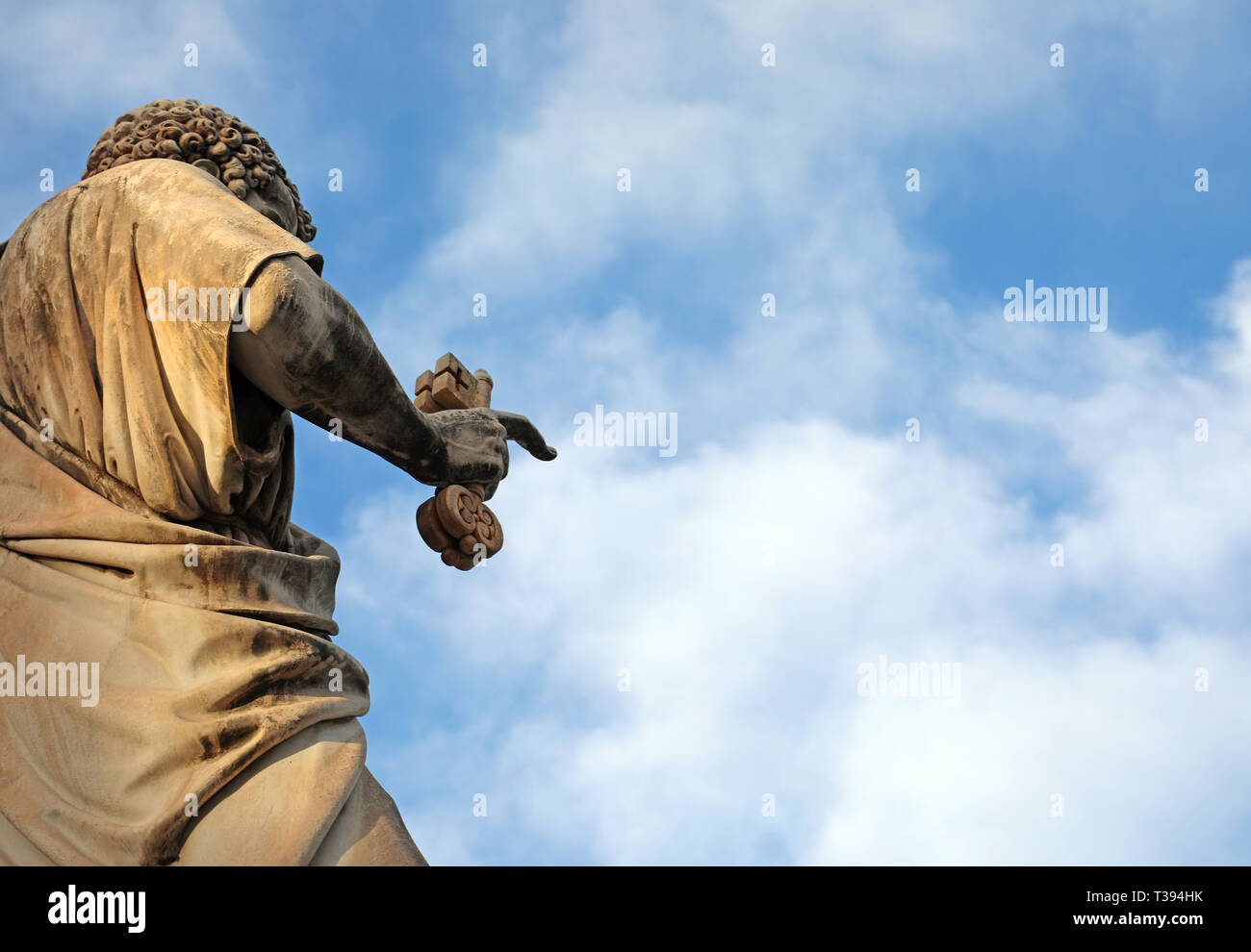 Ancient statue of Saint Peter in key on the hand and blue sky on ...