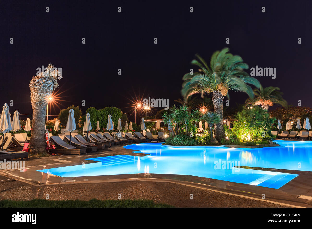 Tropical swimming pool in night view - vacation background Stock Photo ...