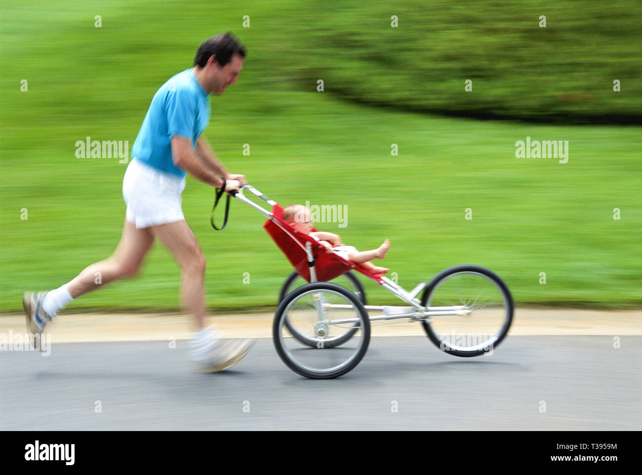 Father Jogging with his baby daughter in stroller, USA 1992 Stock Photo ...