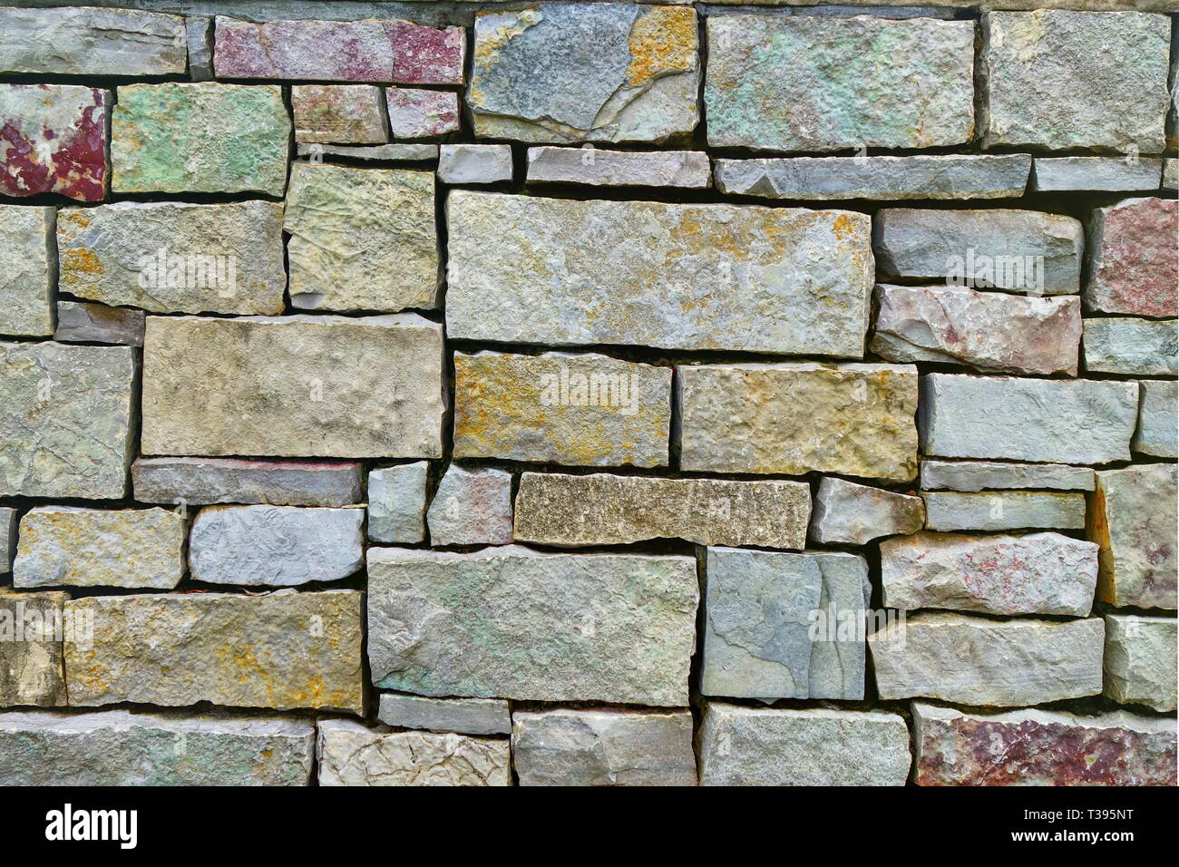 Tight joints in a colorful masonry wall Stock Photo - Alamy