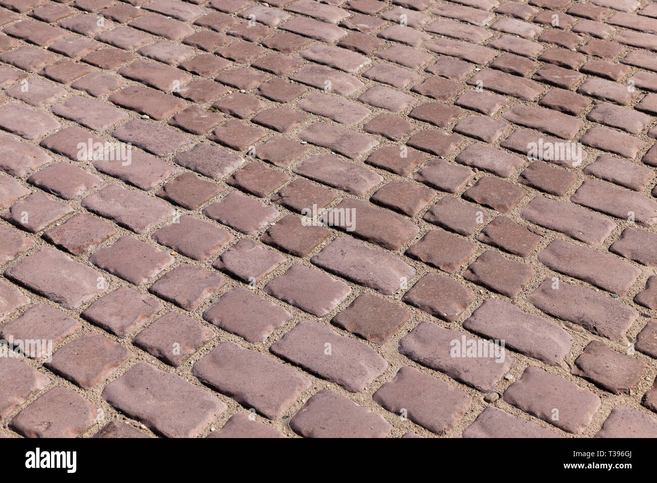 Road for pedestrians from cobblestone tiles in the old part , Europe ...