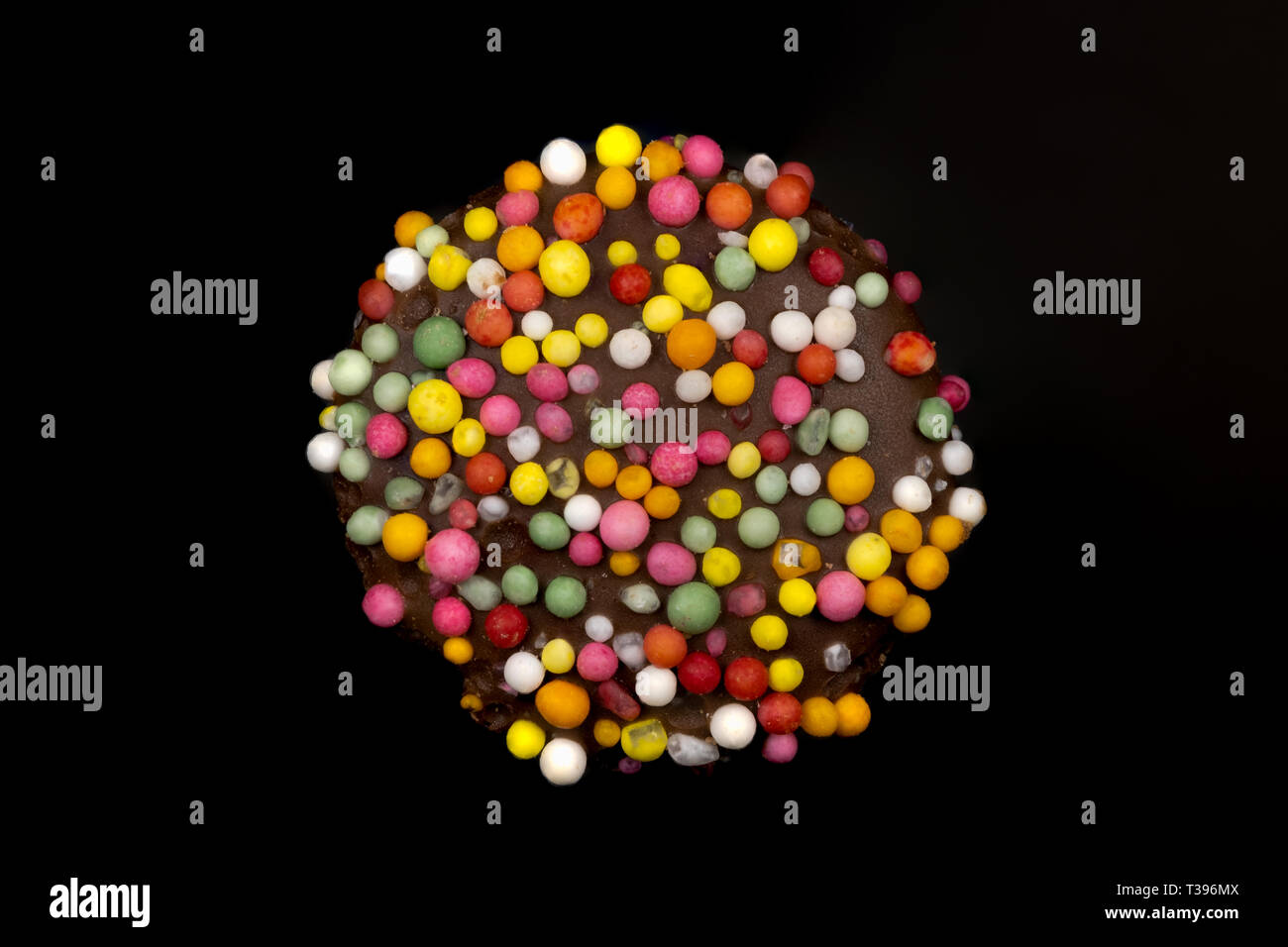 Macro image of a 'freckle', chocolate bud coated in sprinkles, isolated ...