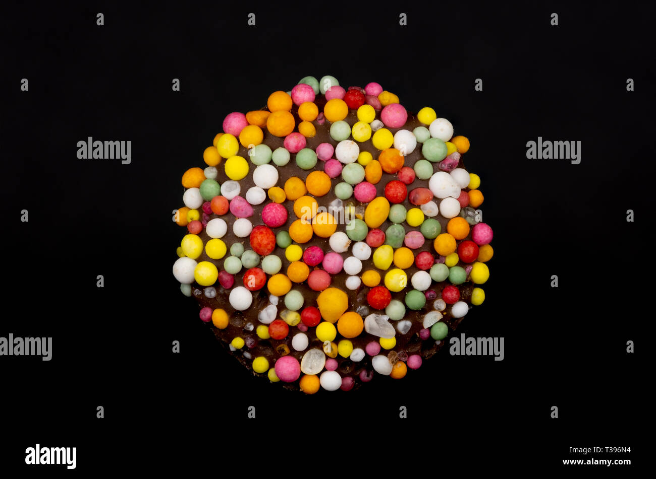 Macro image of a 'freckle', chocolate bud coated in sprinkles, isolated ...