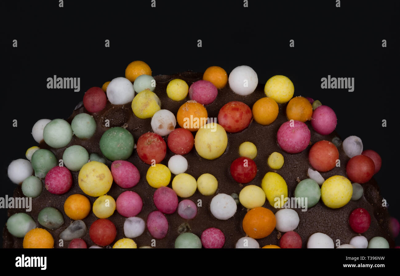 Macro image of a 'freckle', chocolate bud coated in sprinkles, isolated ...