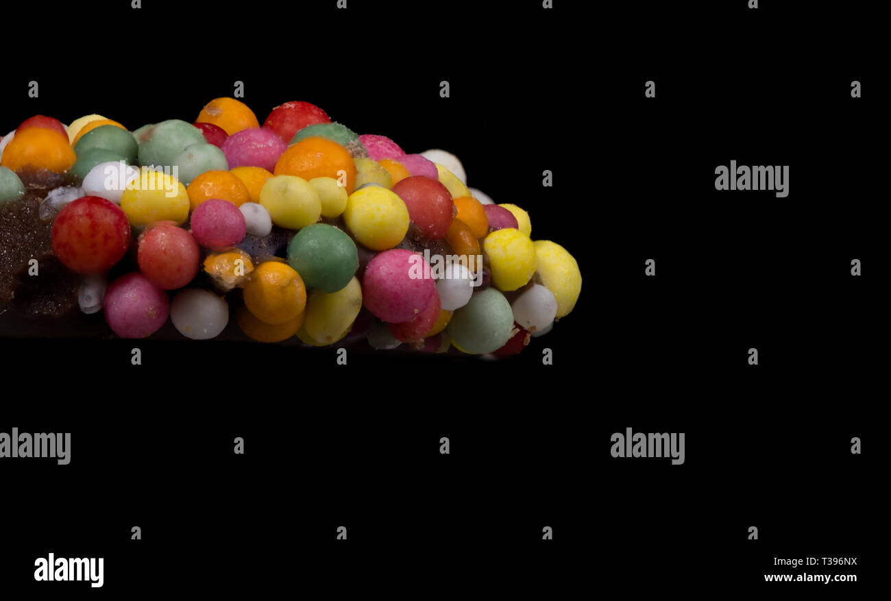 Macro image of a 'freckle', chocolate bud coated in sprinkles, isolated ...